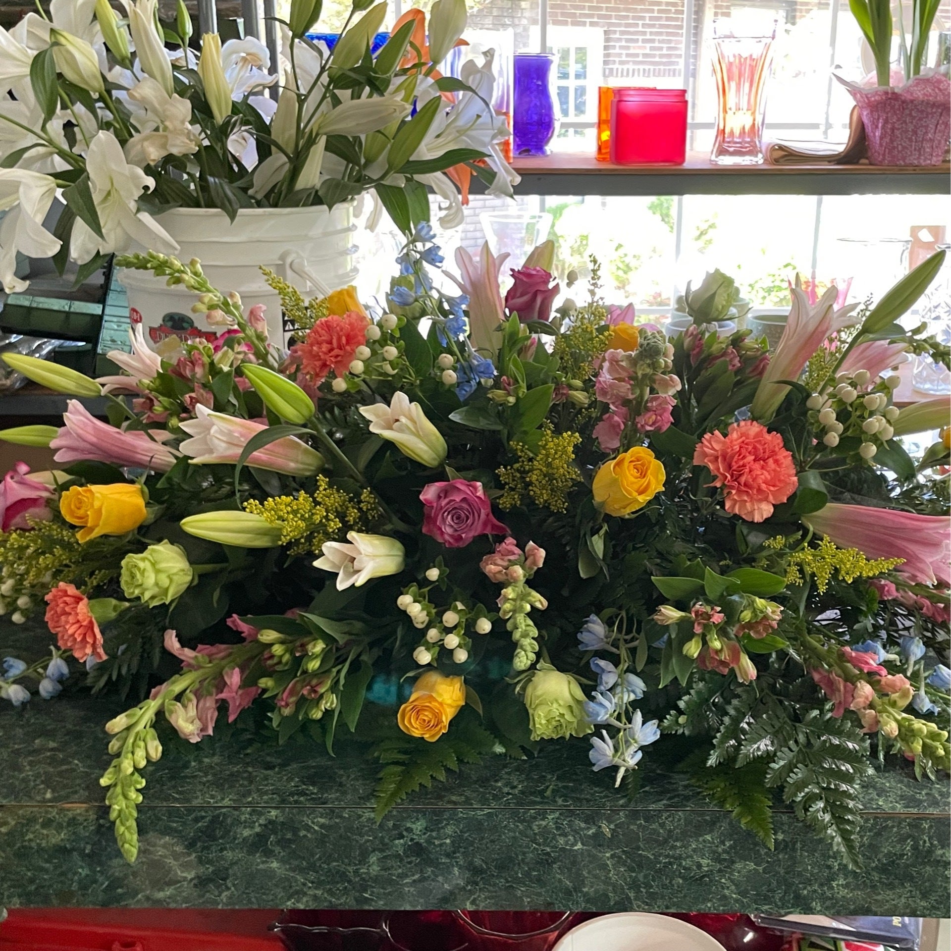 Colorful Spirit Casket Spray | A Ring Around the Roses